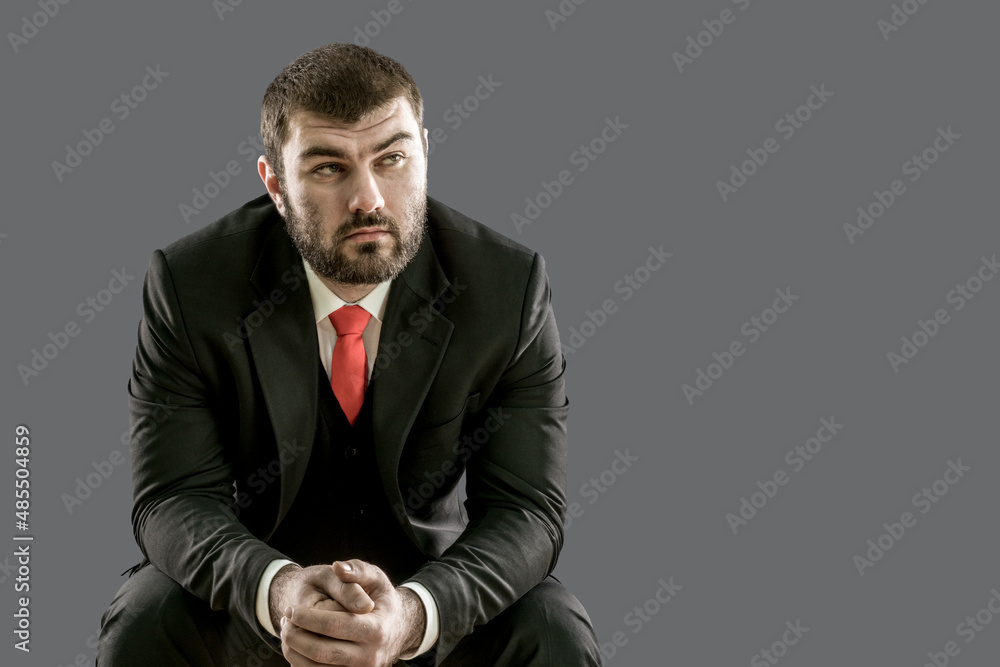 Brutal handsome man with a beard in a suit and red tie for a business ...