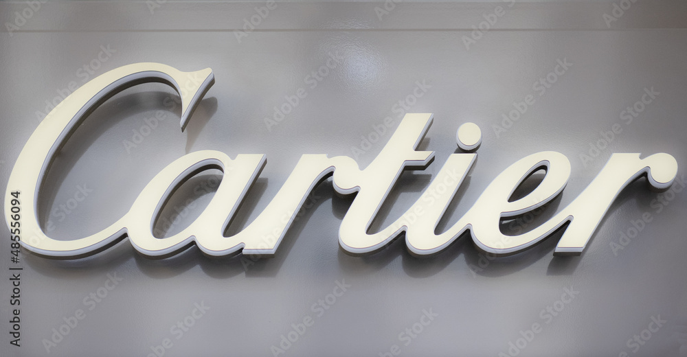 Cartier, sign and logo of the prestigious French brand on the window of ...