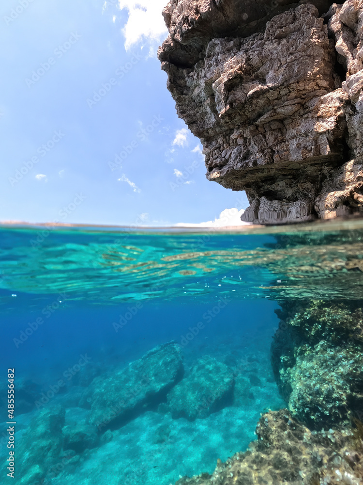Underwater split photo of natural exotic island rocky bay with ...