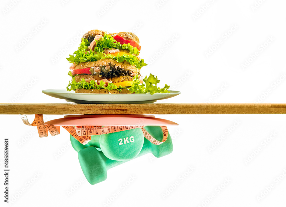 burger vs fitness, dumbbell and measuring tape versus fast food ...