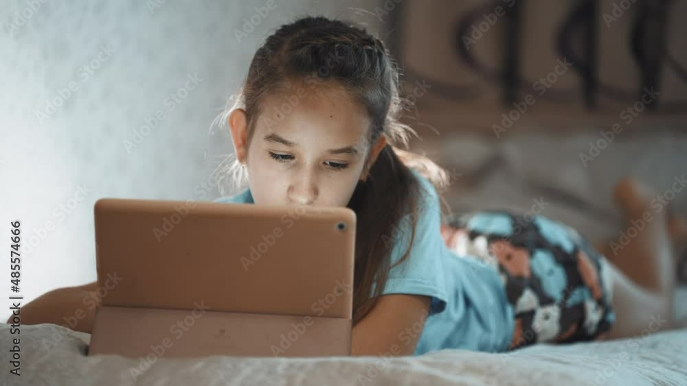 Kid child girl holding digital tablet. Teenager learning at home. Child ...