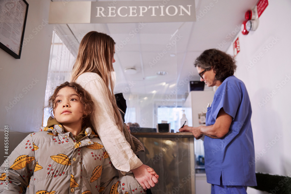 Female doctor with patients at reception desk Stock Photo | Adobe Stock
