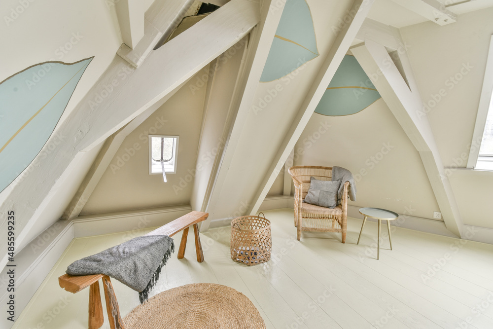 Interior of mansard with rattan armchair Stock Photo | Adobe Stock