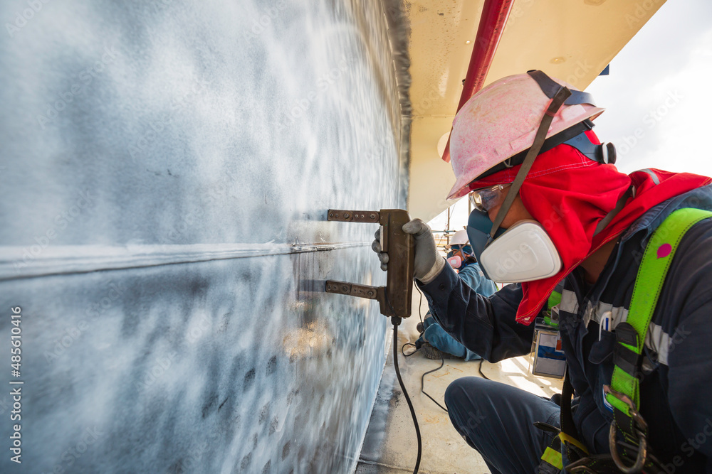 A male worker at high test steel tank butt weld carbon shell plate of ...