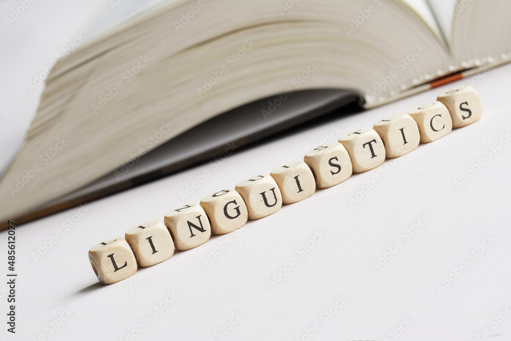 Word linguistics next to an open book. The concept of studying ...