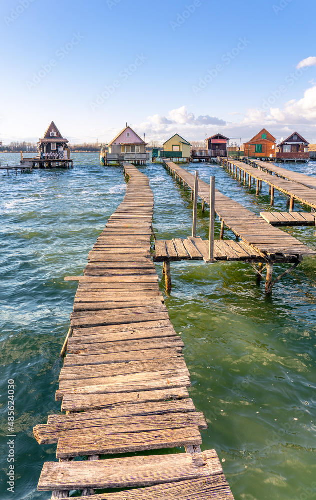floating village bungalows in Bokod Hungary wit wooden pier walkway ...