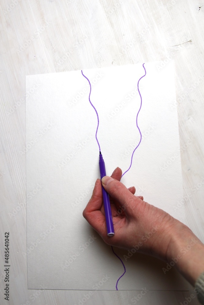 hand drawing with purple marker and random wave line on white paper ...