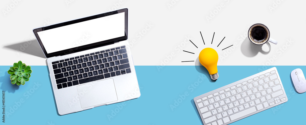 Computers with a light bulb from above Stock Photo | Adobe Stock