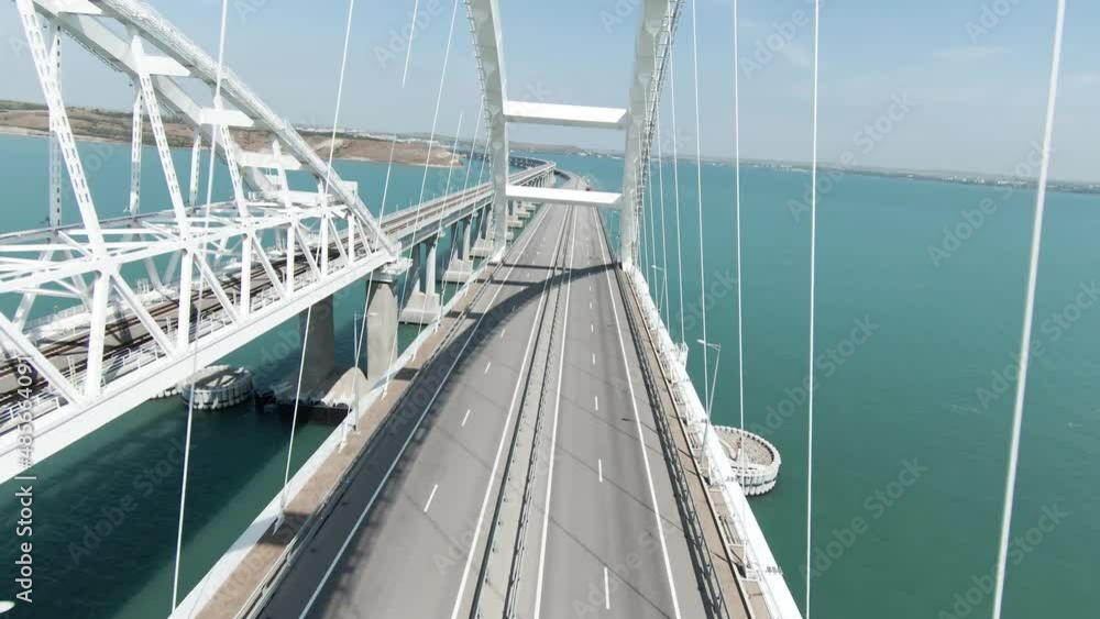 Huge bridge. Drone view. Action. A long bridge over the ocean on which ...