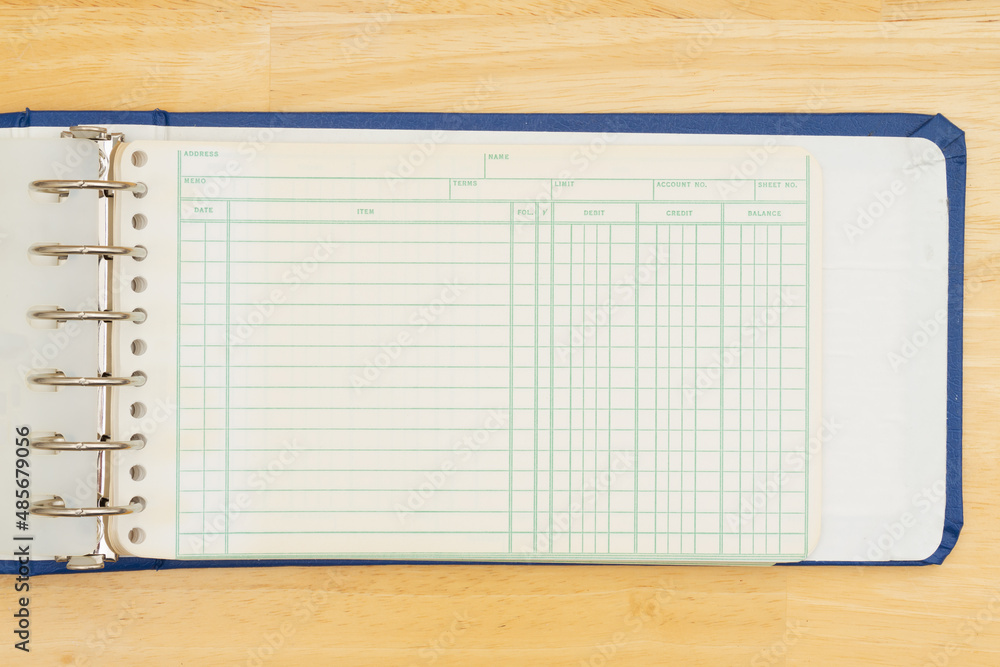 Paper ledger on a wood desk Stock Photo | Adobe Stock