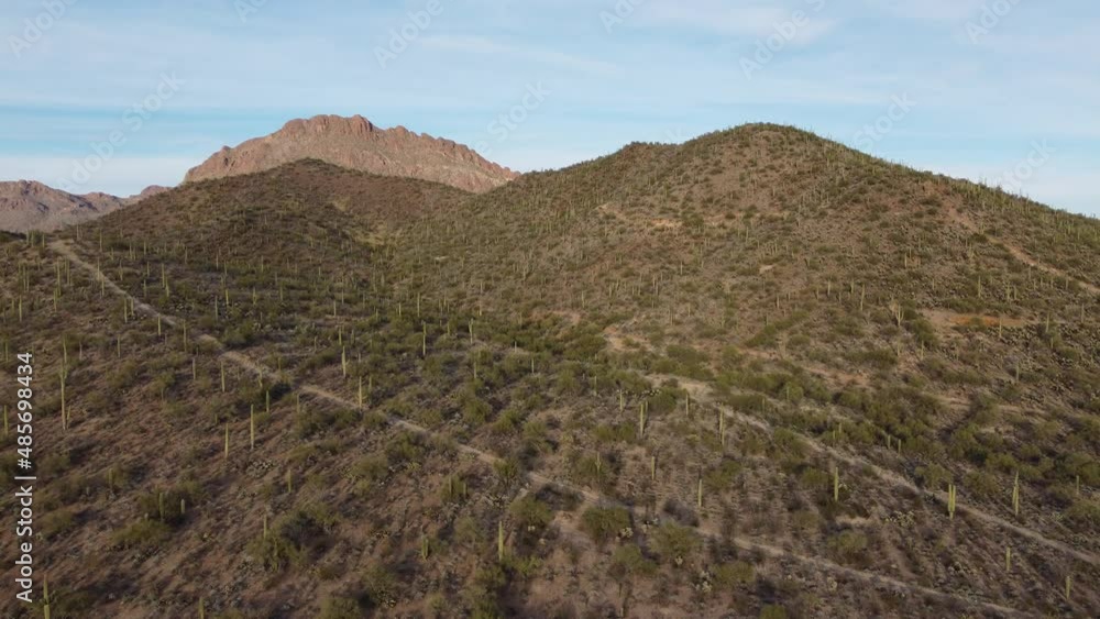 Drone flying in wilderness area of Tucson Arizona revealing trails, one ...