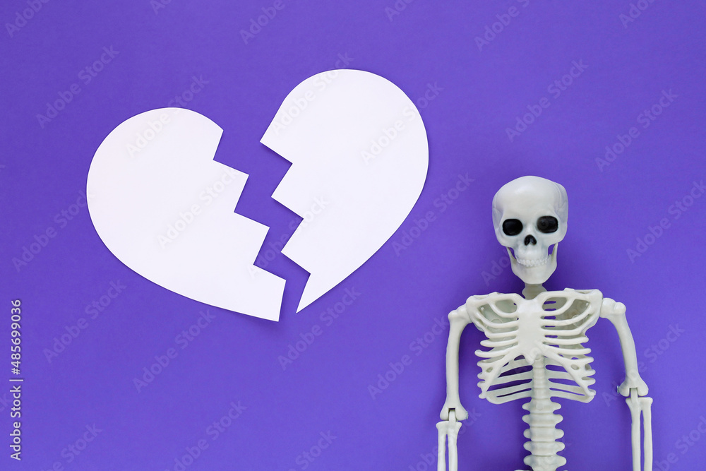 Skeleton on violet background with white blank paper cut big broken ...