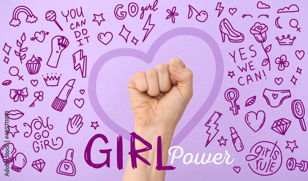 Hand of woman with clenched fist and text GIRL POWER on color ...