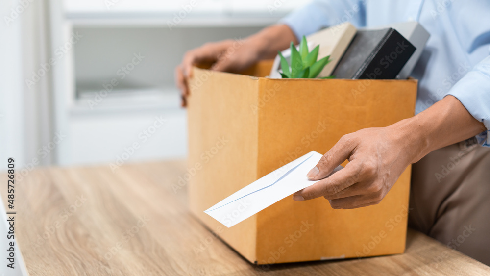 Resignation Concept The male officer standing, putting his box of his ...