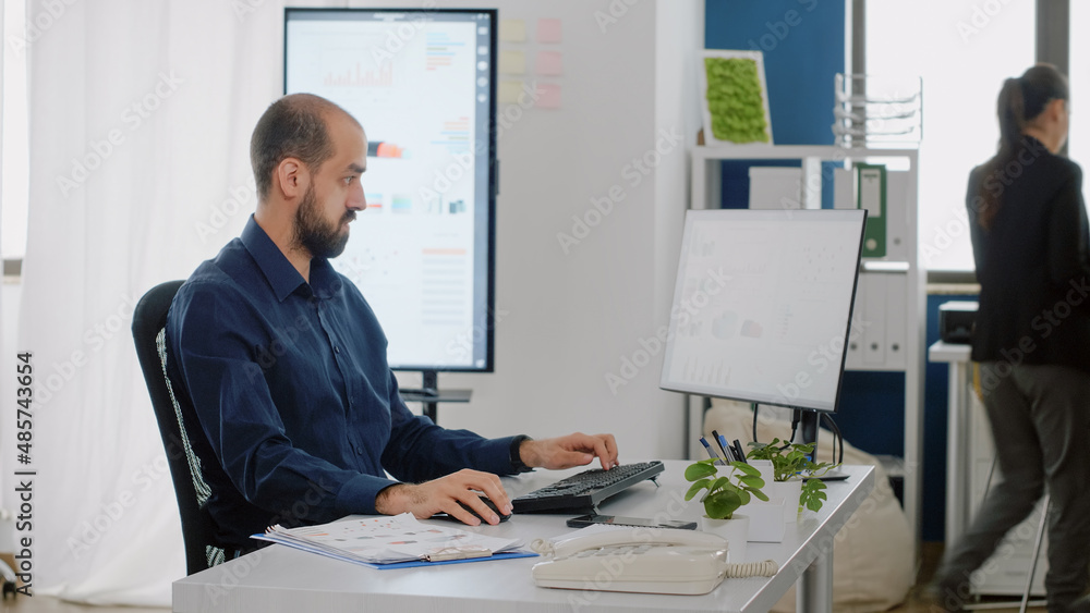 Businessman typing on keyboard for corporate work, using computer ...