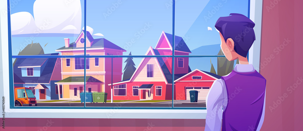 Lonely man stand at window rear view look on street with suburban ...