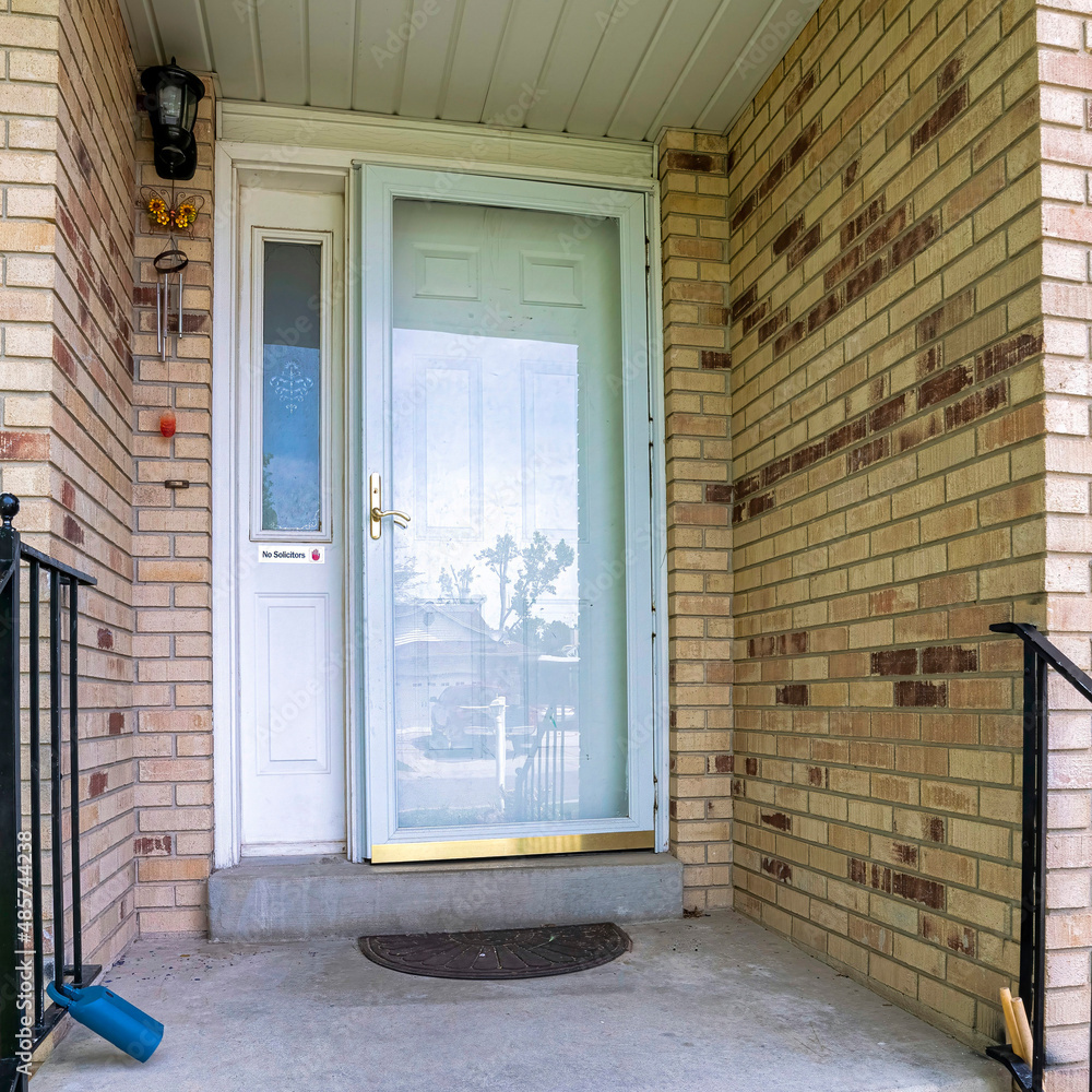 Square Front door of a house with bricks and metal railings Stock Photo ...