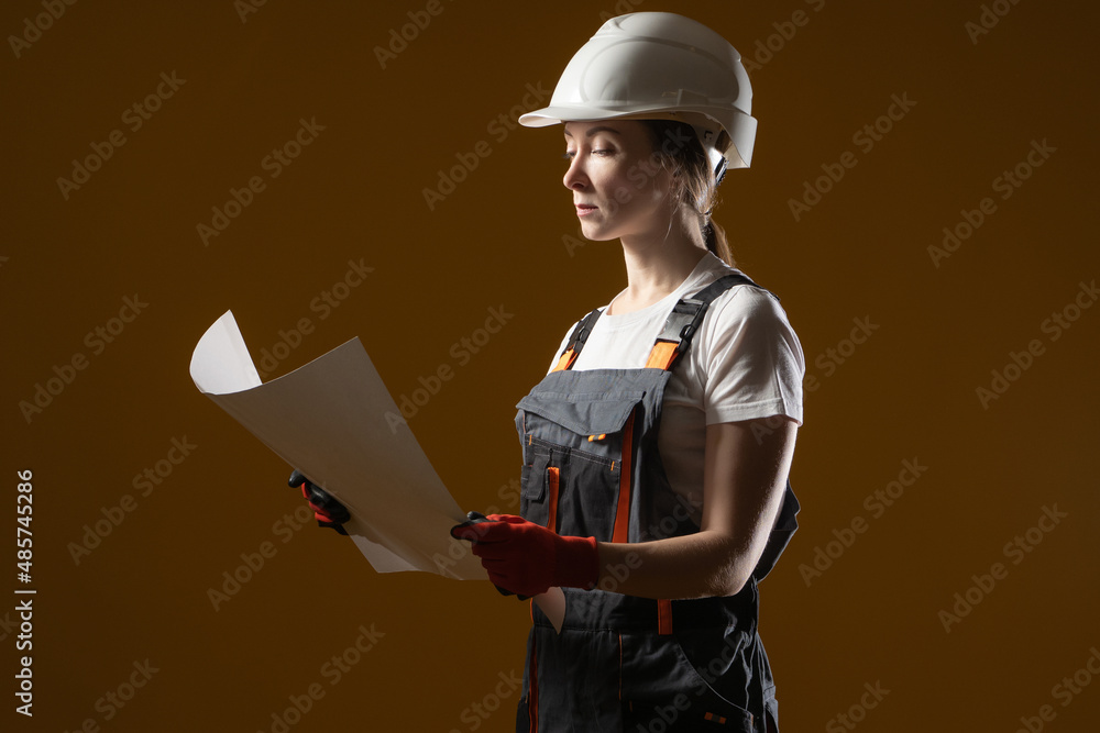 Woman Builder. Girl in uniform of repairwoman. Girl works as ...