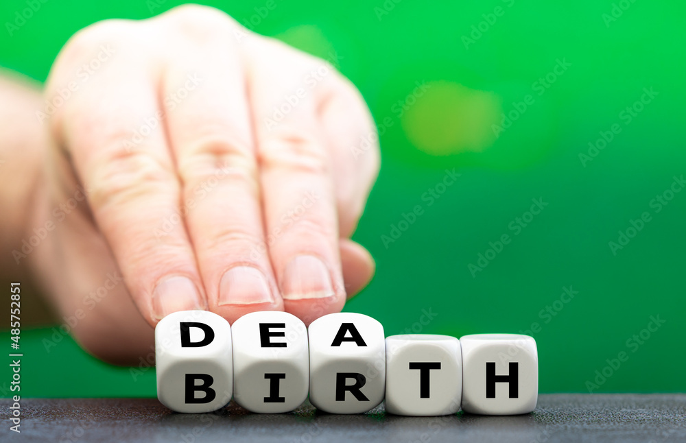 Symbol for the cycle of life. Hand turns dice and changes the word ...