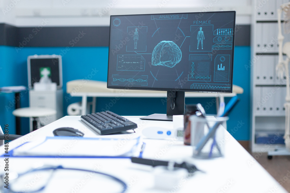 Computer standing on table in empty doctors office having body ...