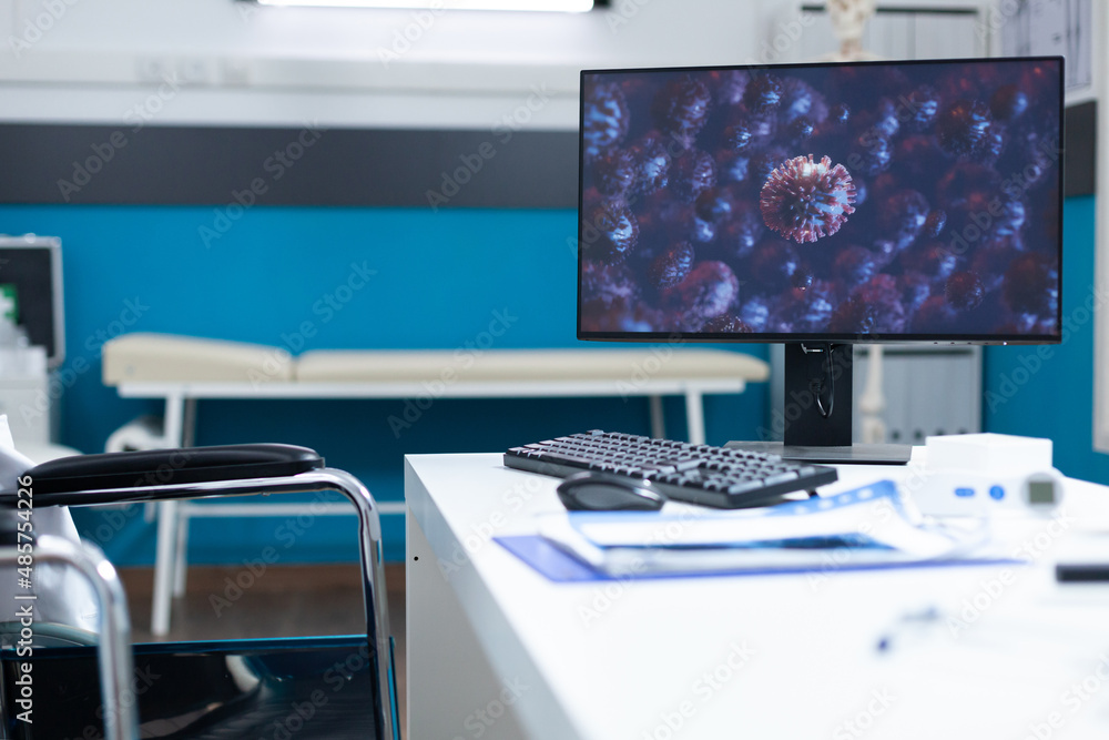 Empty bright medical office with computer standing on desk table having ...