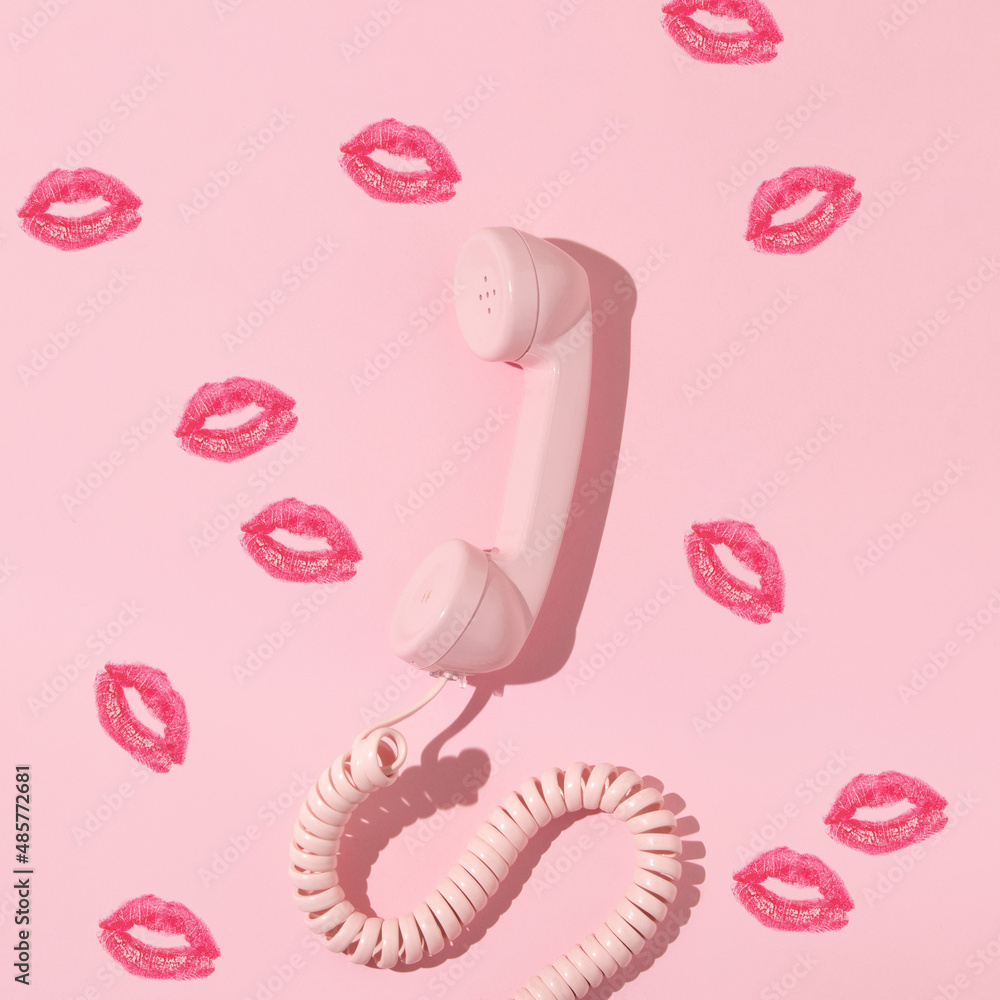 Valentines day creative layout with pink retro phone handset and kiss ...