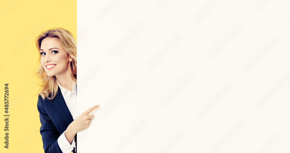 Happy smiling pointing businesswoman in dark blue confident suit ...