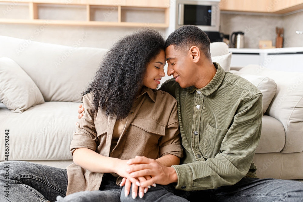 Smiling man bonding to his charming multiracial woman. Two people ...