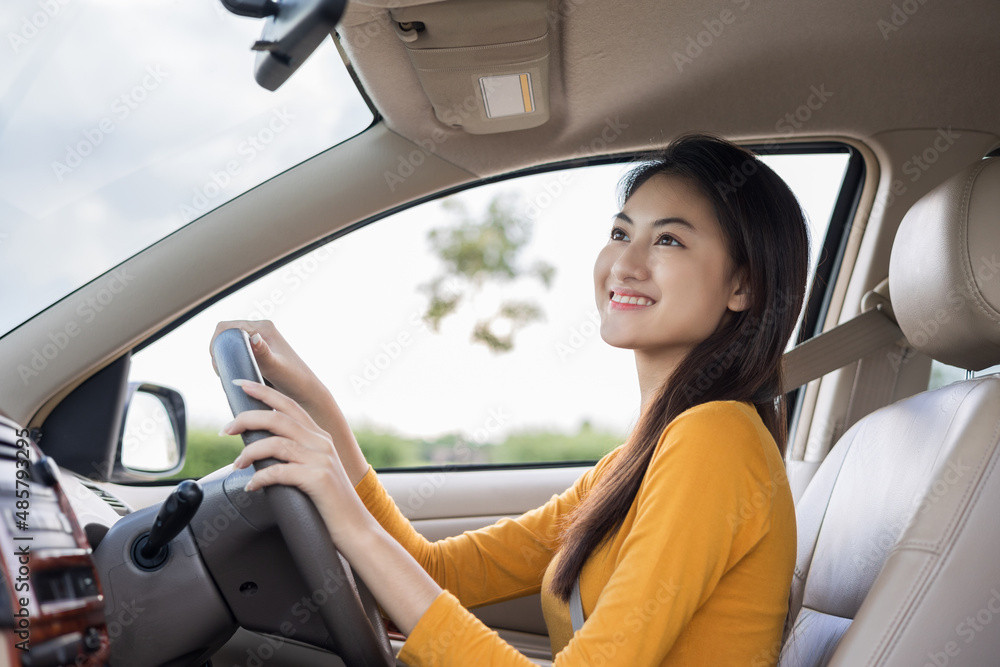 Young beautiful asian women getting new car. she very happy and excited Look the rearview mirror ...