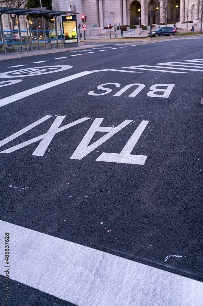 Horizontal taxi and bus signage on a paved street Stock Photo | Adobe Stock