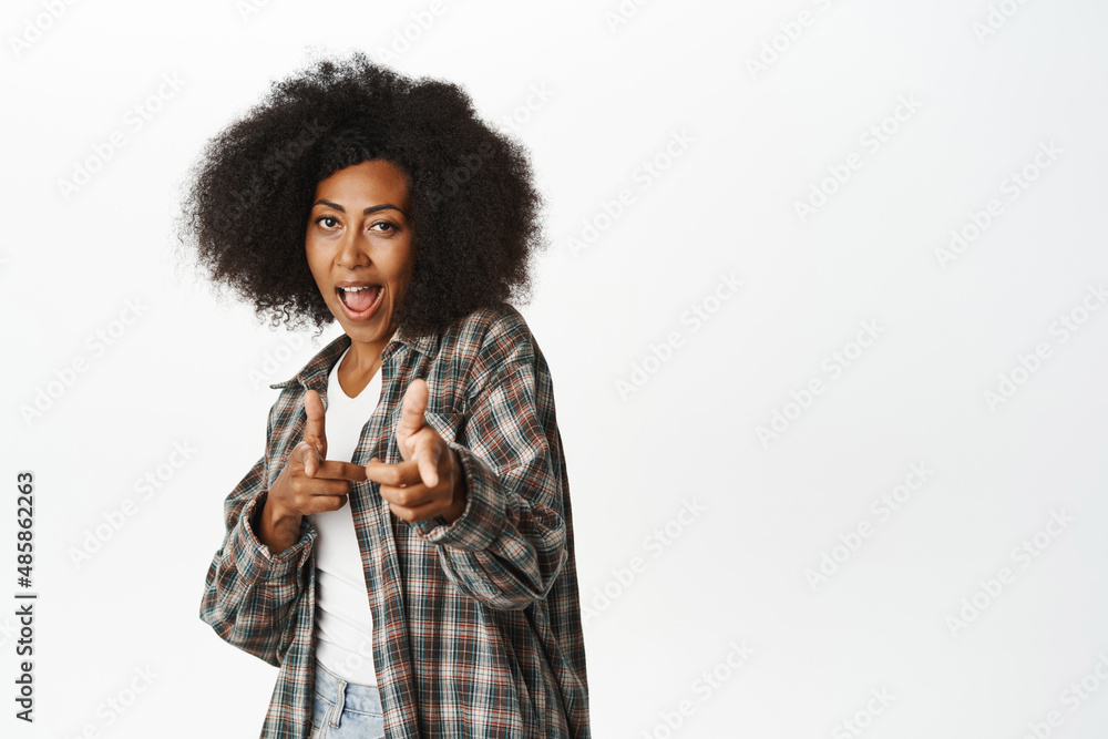 Bang. Happy african american woman pointing fingers at camera, choosing ...