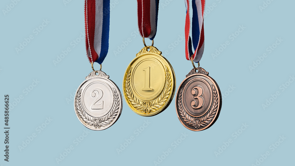 real Gold, silver and bronze medals hanging on red ribbons isolated on ...