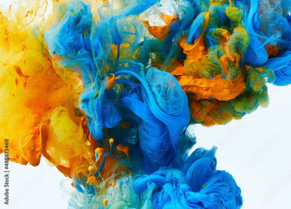 Blue and yellow paint splash curves in water close up. Acrylic paint ...