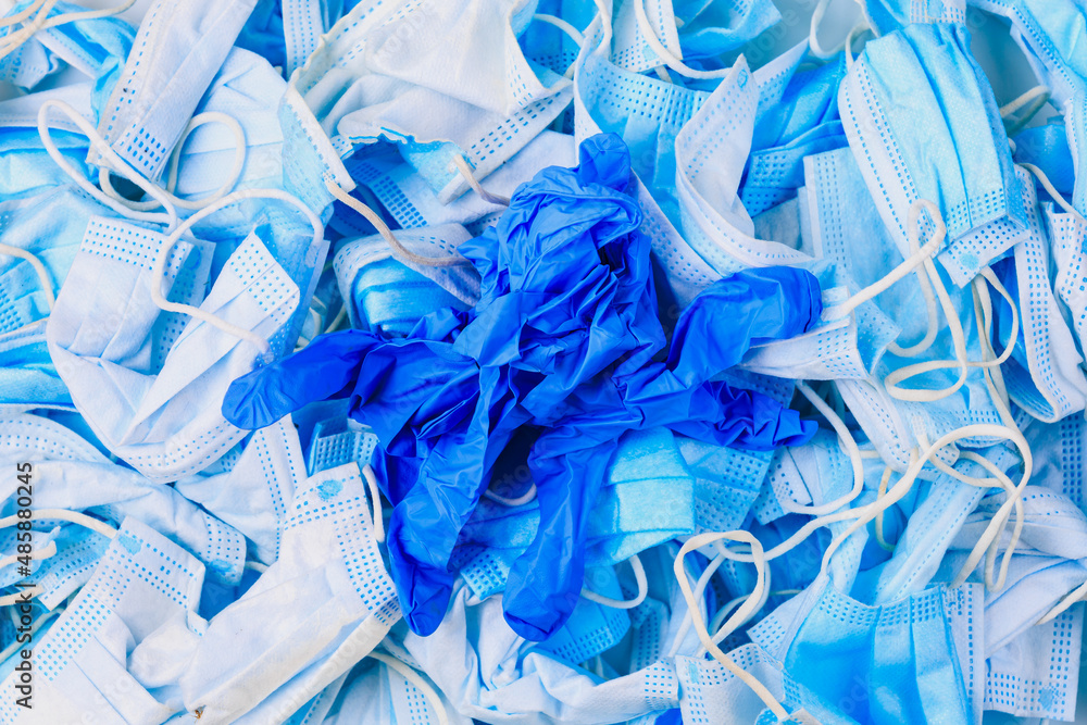 Used disposable medical masks and gloves background. Medical waste ...
