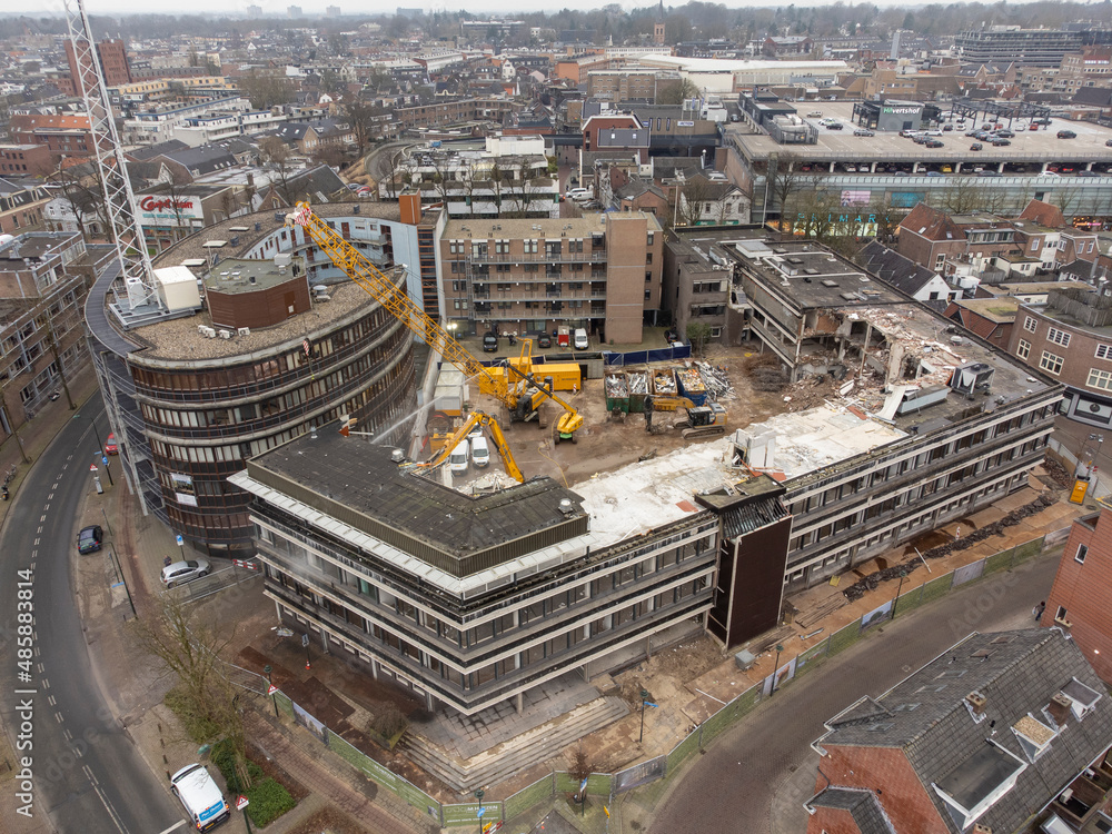 Demolition of a police station using building hydraulic shears, aerial ...