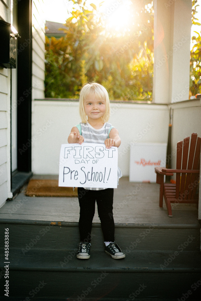 child holds a first day of preschool sign Stock Photo | Adobe Stock