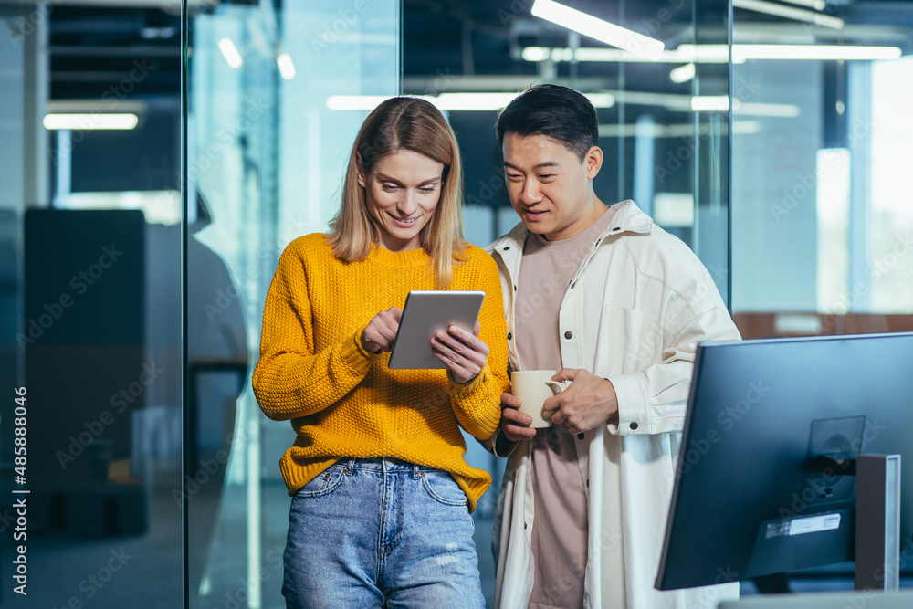 Two employees are having fun. during the break an Asian man and a ...