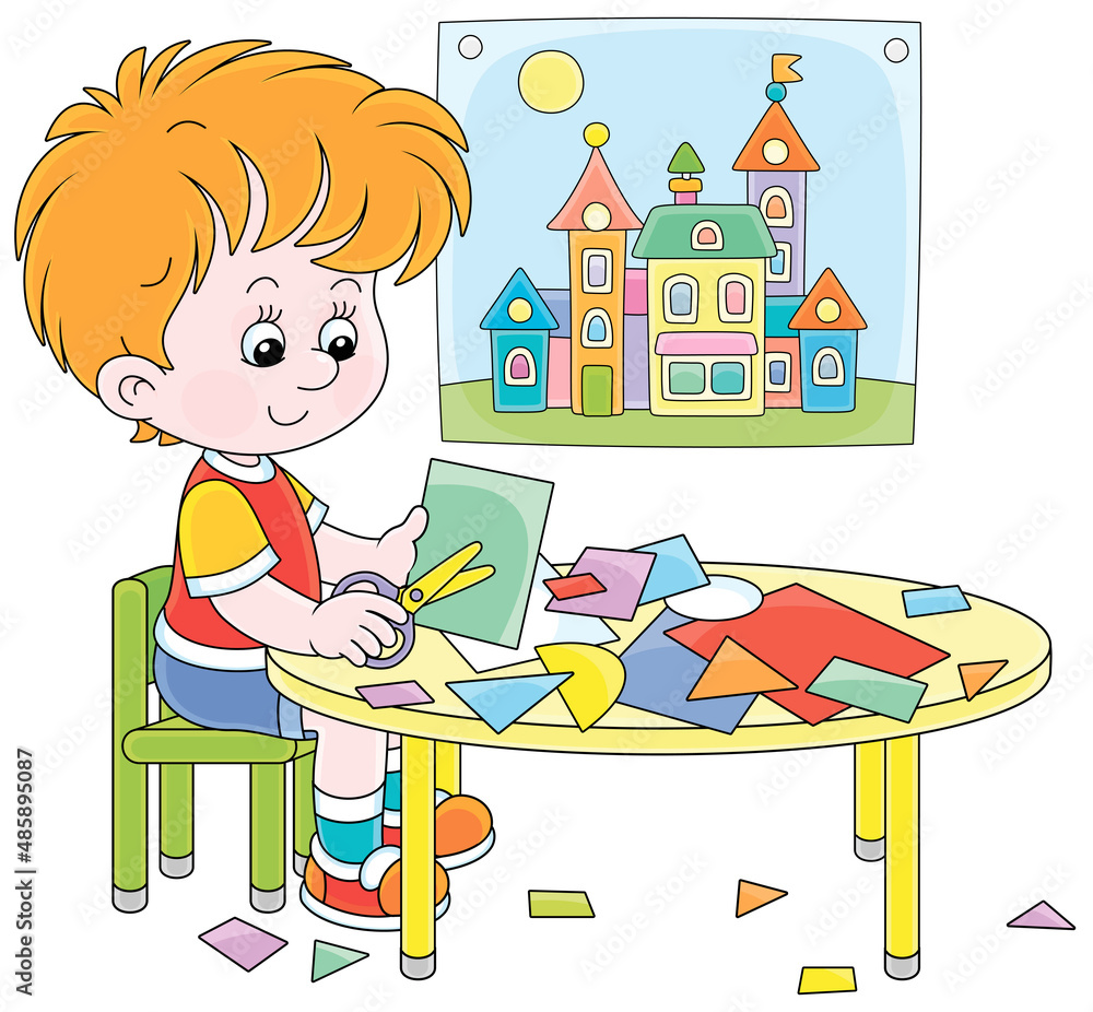 Little preschool child cutting outlines and figures from color paper ...