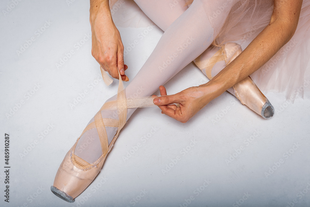 feet in pointe shoes. Legs of a young female ballerina on a white ...