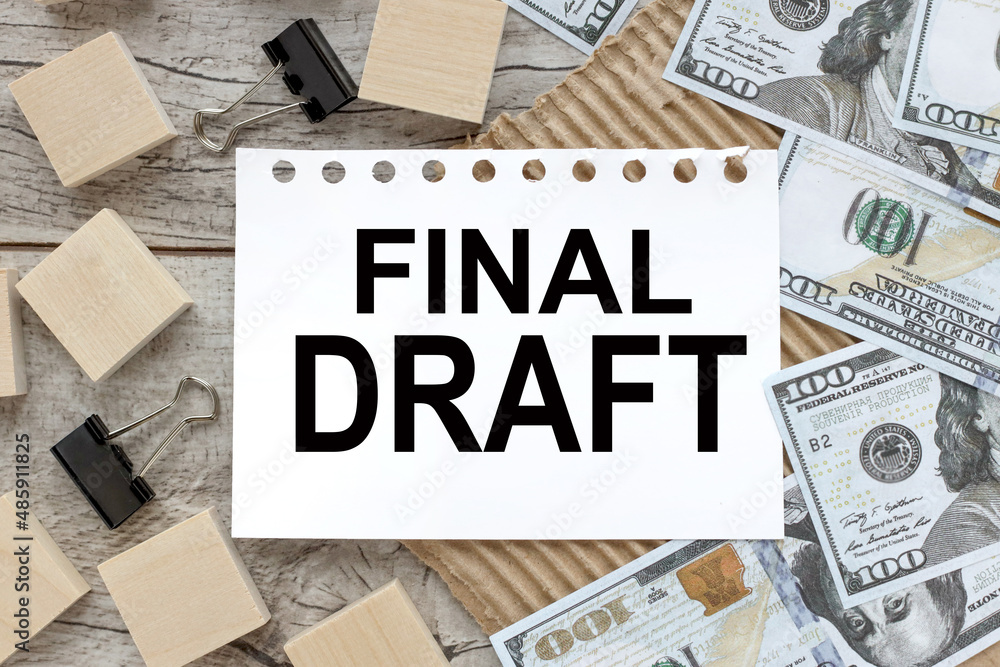 FINAL DRAFT text on white page near wooden blocks and black clips ...