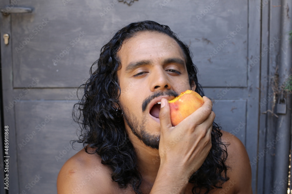 Man eating an irresistible looking peach Stock Photo | Adobe Stock