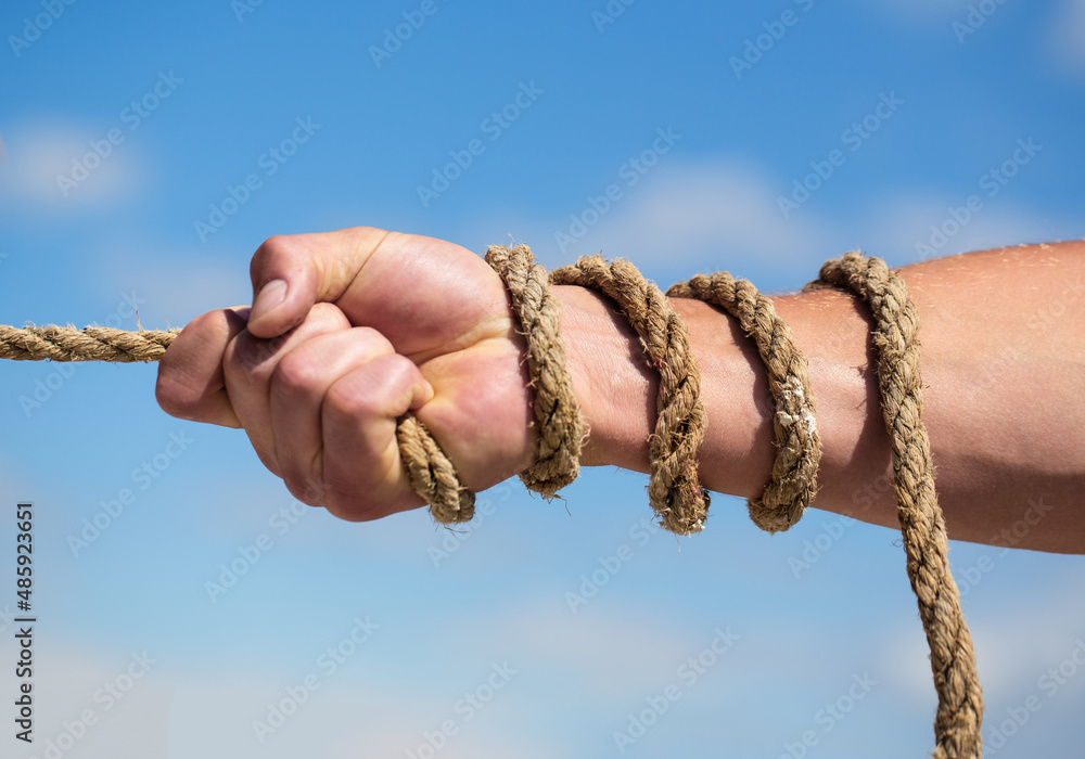 Helping hand, arm, friendship. Rope, cord. Hand holding a rope ...