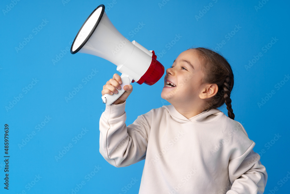 Child girl using megaphone against blue background Stock Photo | Adobe ...
