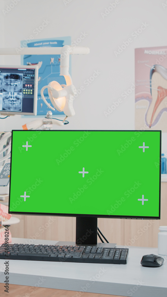 Horizontal green screen on computer in dentist office while specialists ...