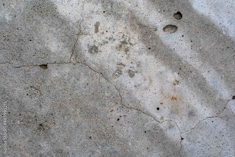 Texture of concrete with a crack in the middle with pits, holes. Close ...