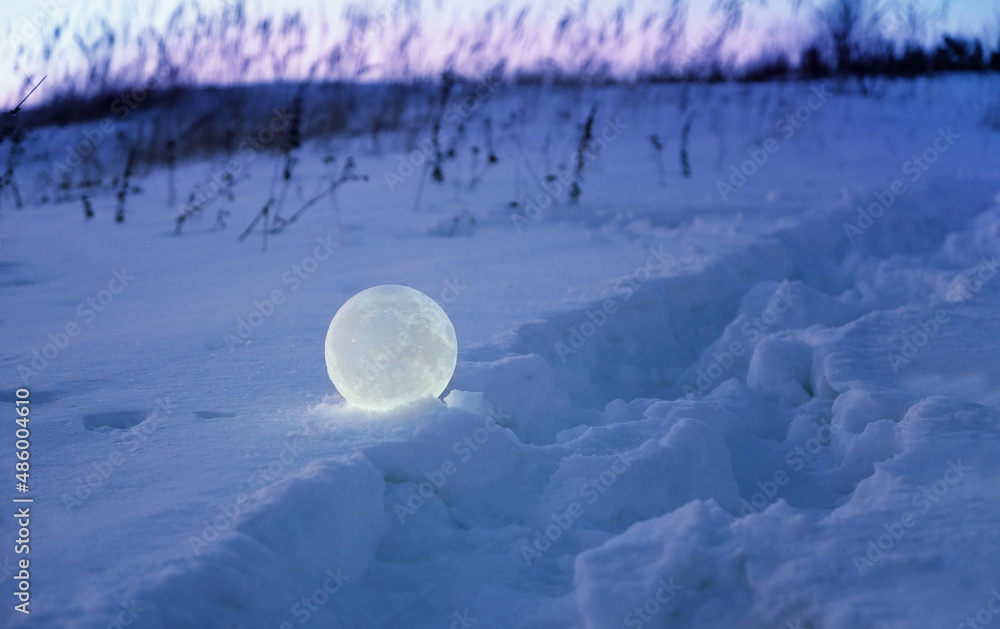 decorative moon on snow, evening natural background. beautiful ...