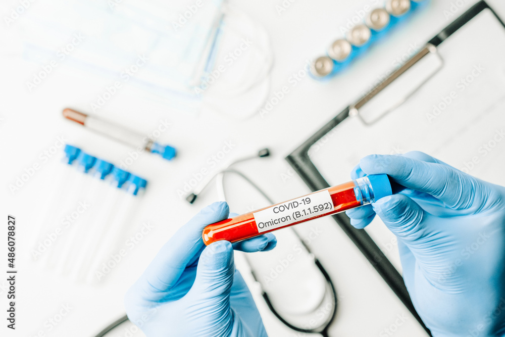Omicron corona virus variant. Medical laboratory doctor holding test ...