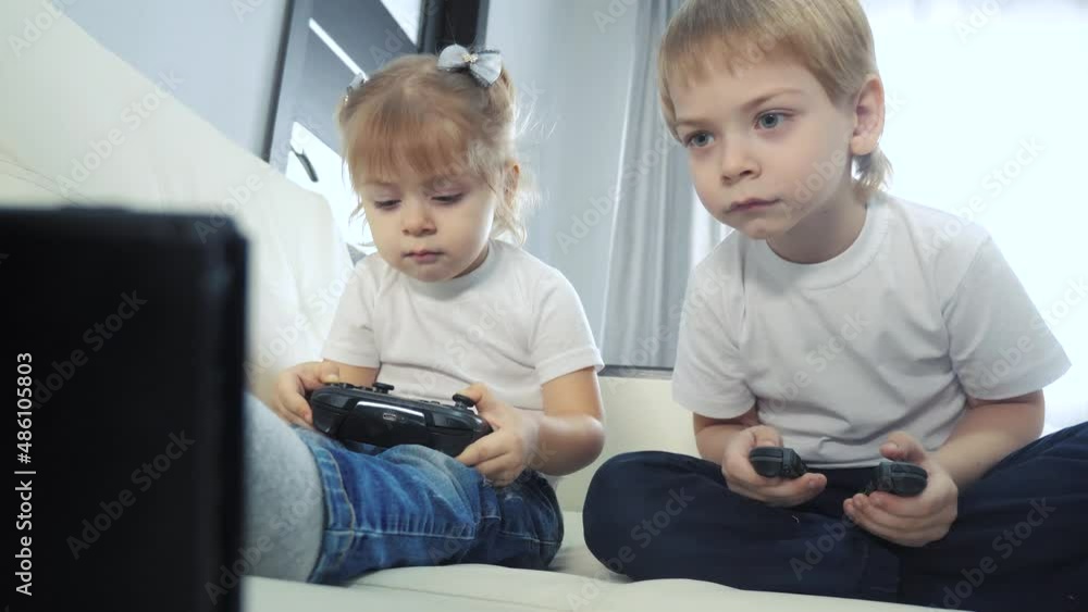 children lifestyle play console in gamepads teamwork. kids a boy and a ...