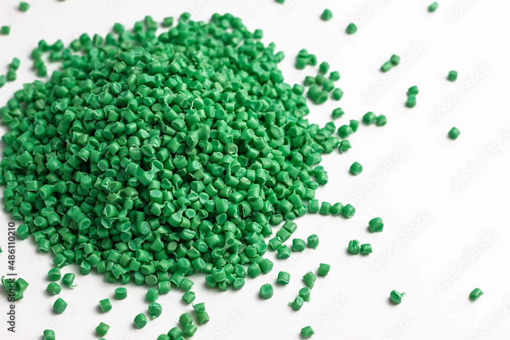 green granules of polypropylene, polyamide. White background. Plastic ...
