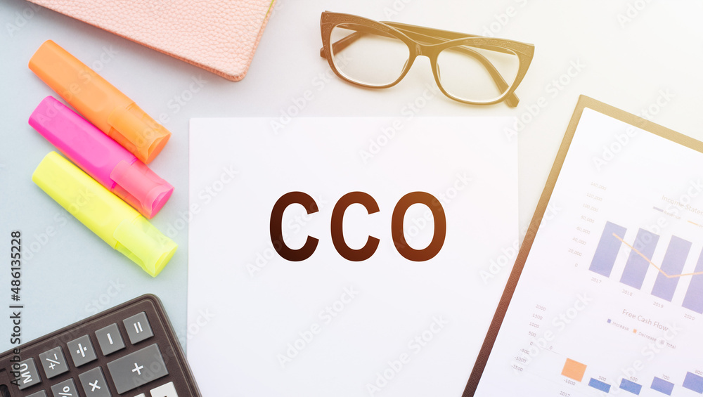 CCO Chief Compliance Officer. Text on notepad and office accessories on ...